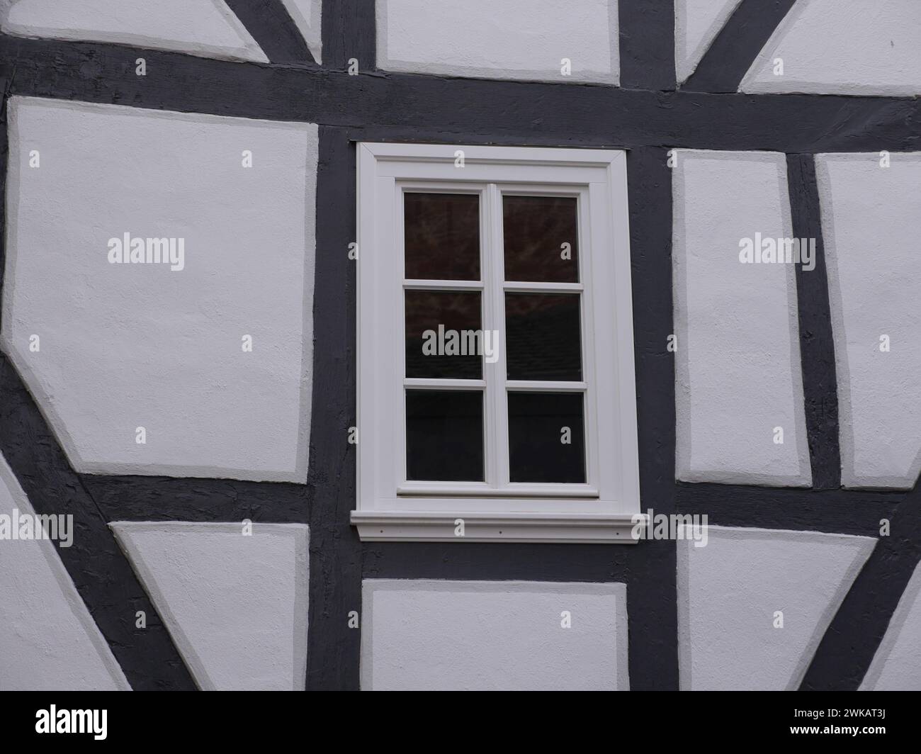 Details of a half-timbered house with a lattice window, over the ...