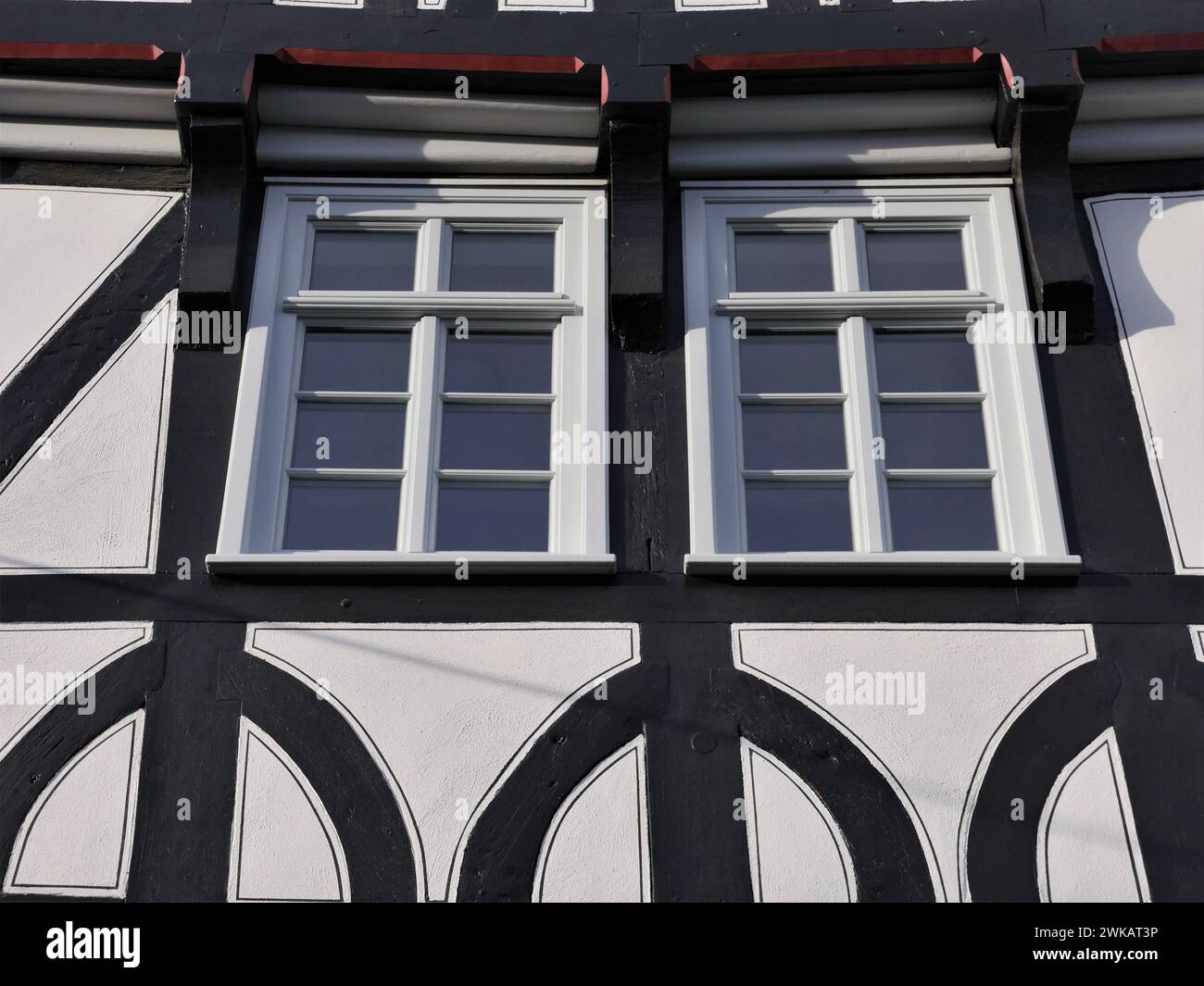 Details of a half-timbered house with two lattice windows, over the ...