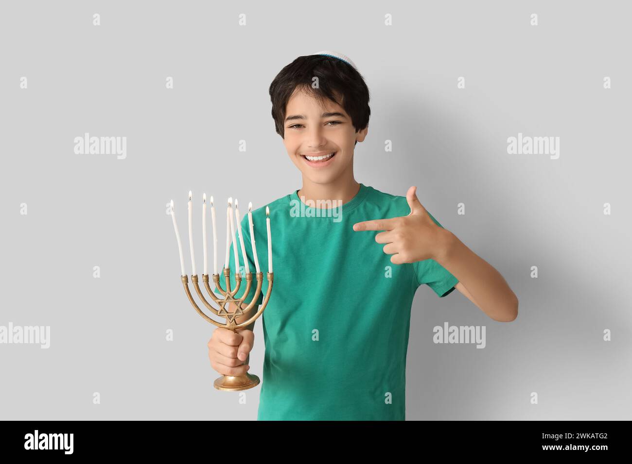 Little Israeli boy pointing at menorah on grey background Stock Photo ...