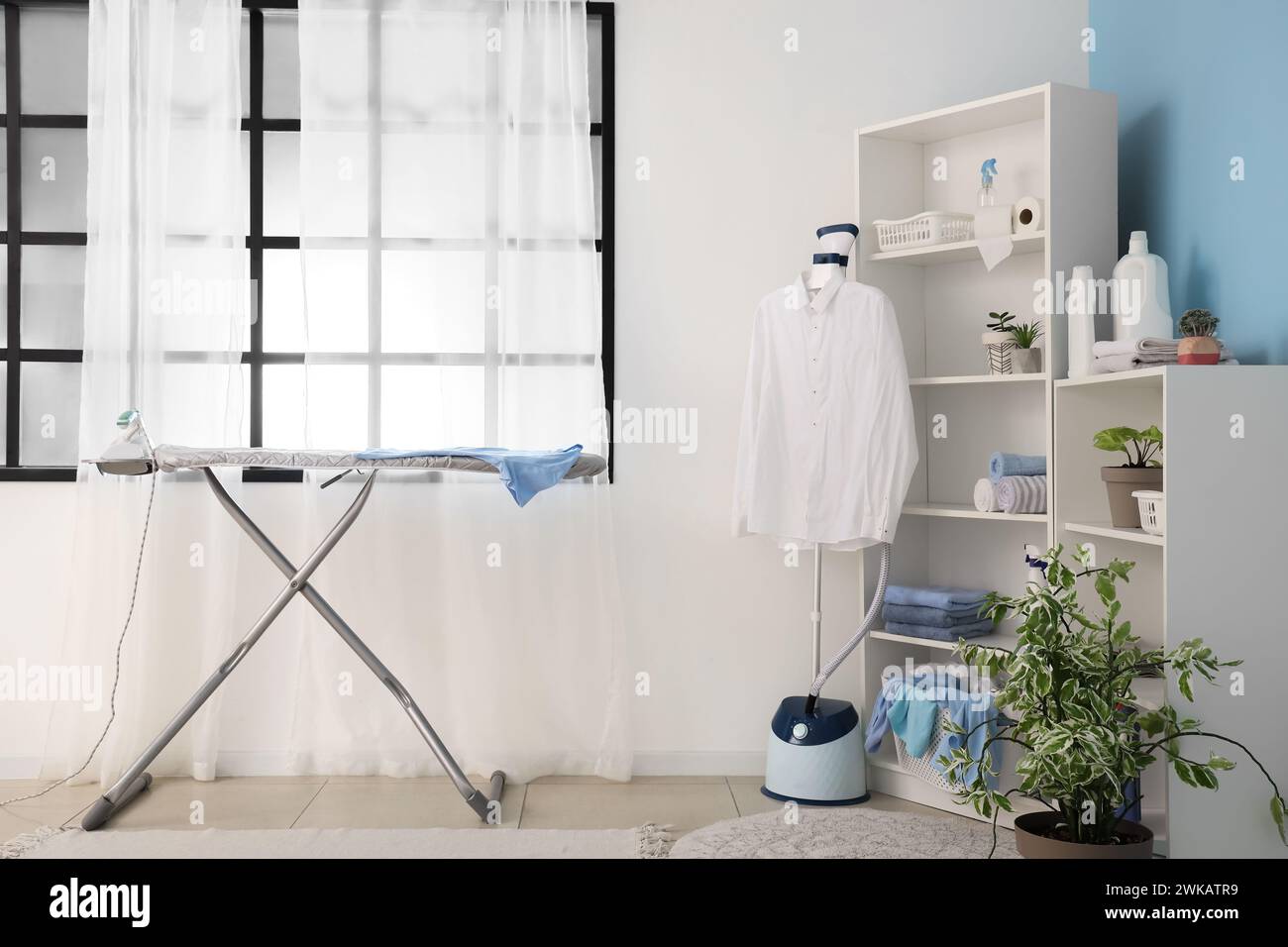 Interior of modern laundry room with ironing board and steamer Stock ...