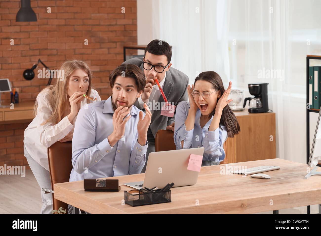 Business colleagues with party blowers in office. April Fools' Day ...