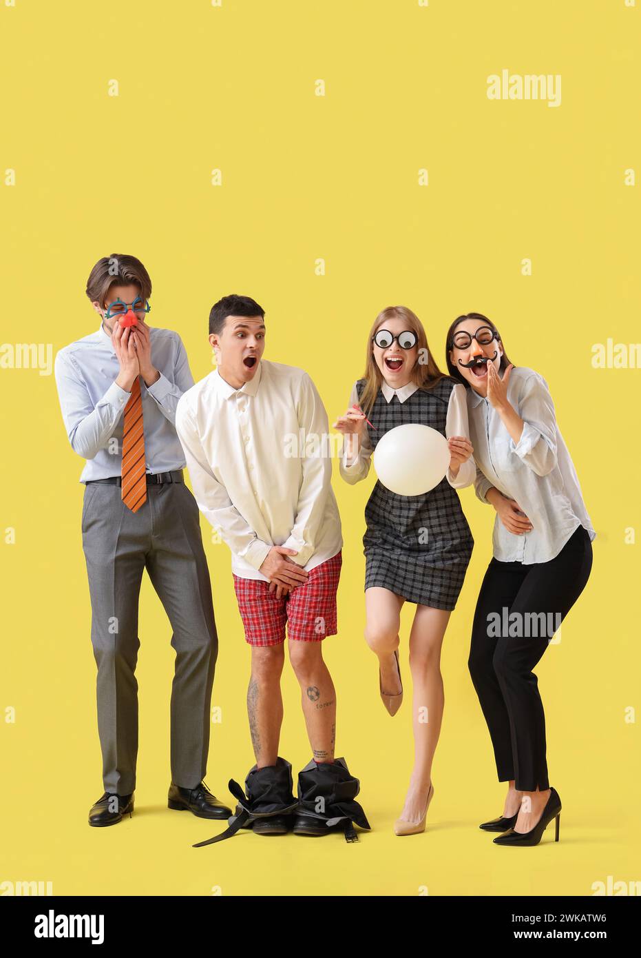 Business man with his pants down and laughing colleagues on yellow ...