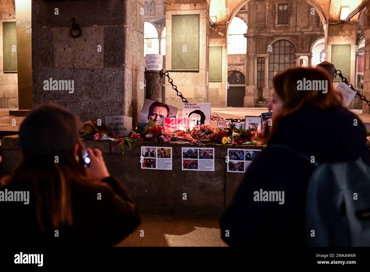 Milan, Italy - February 19, 2024: People stand in front of flowers and ...
