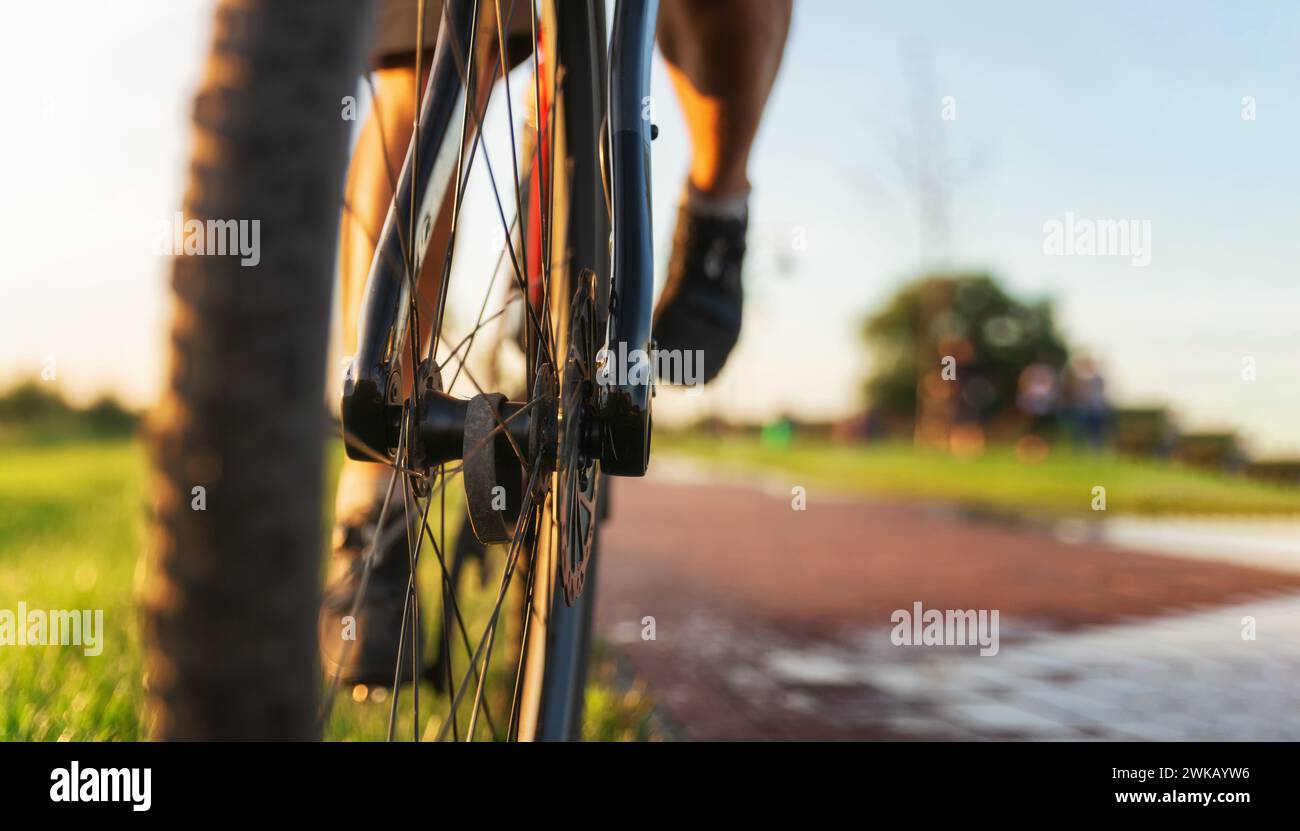 Cyclist on a bike. Front bicycle wheel close up. Sports and active ...