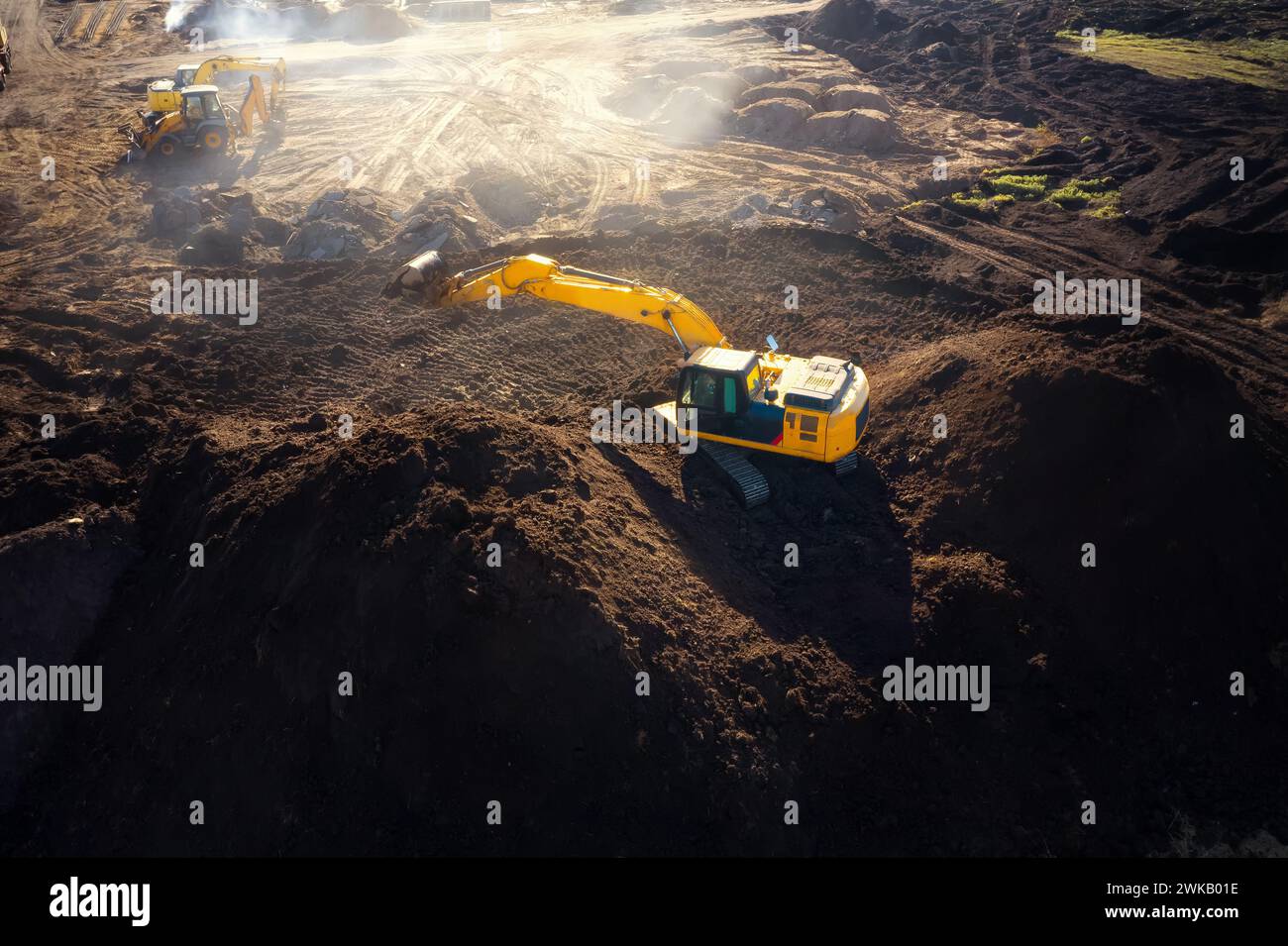 Yellow crawler excavator is working on a construction site Stock Photo ...