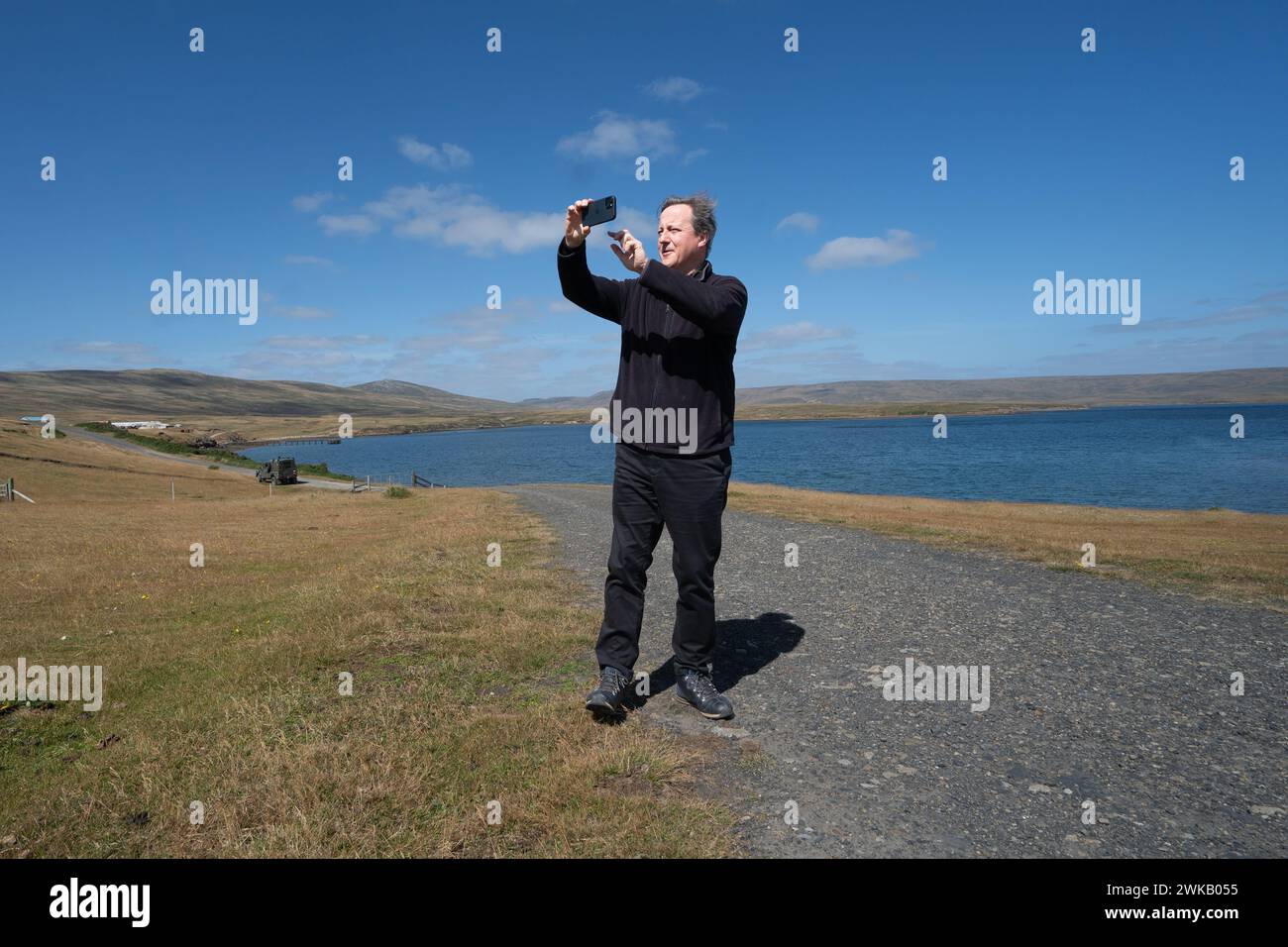 Foreign Secretary Lord David Cameron takes a photograph of San Carlos ...