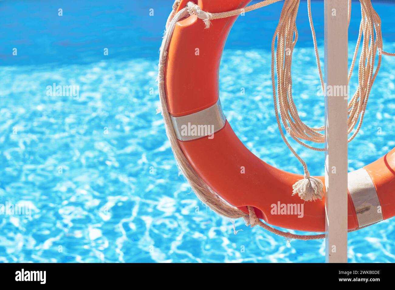 Orange lifebuoy near the swimming pool Stock Photo - Alamy