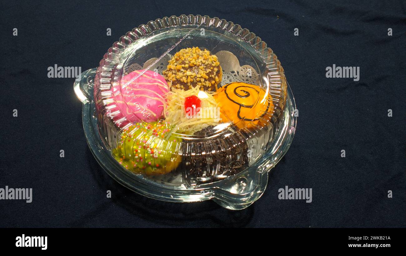 Close up of donuts with various color variants and toppings Stock Photo ...