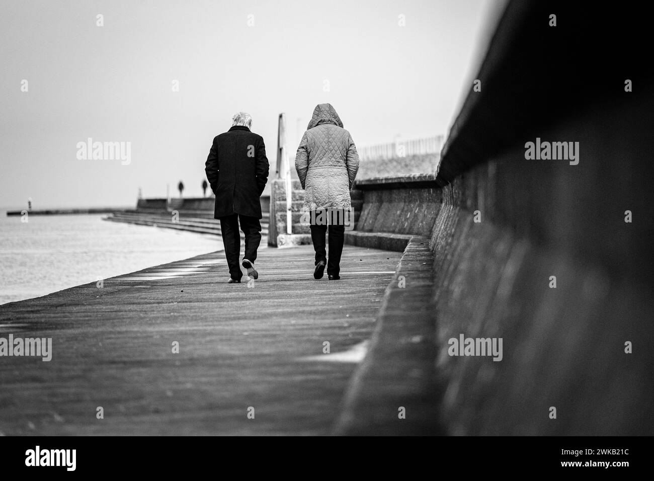 Walking along the sea defences at Silloth, Cumbria, England, UK Stock ...