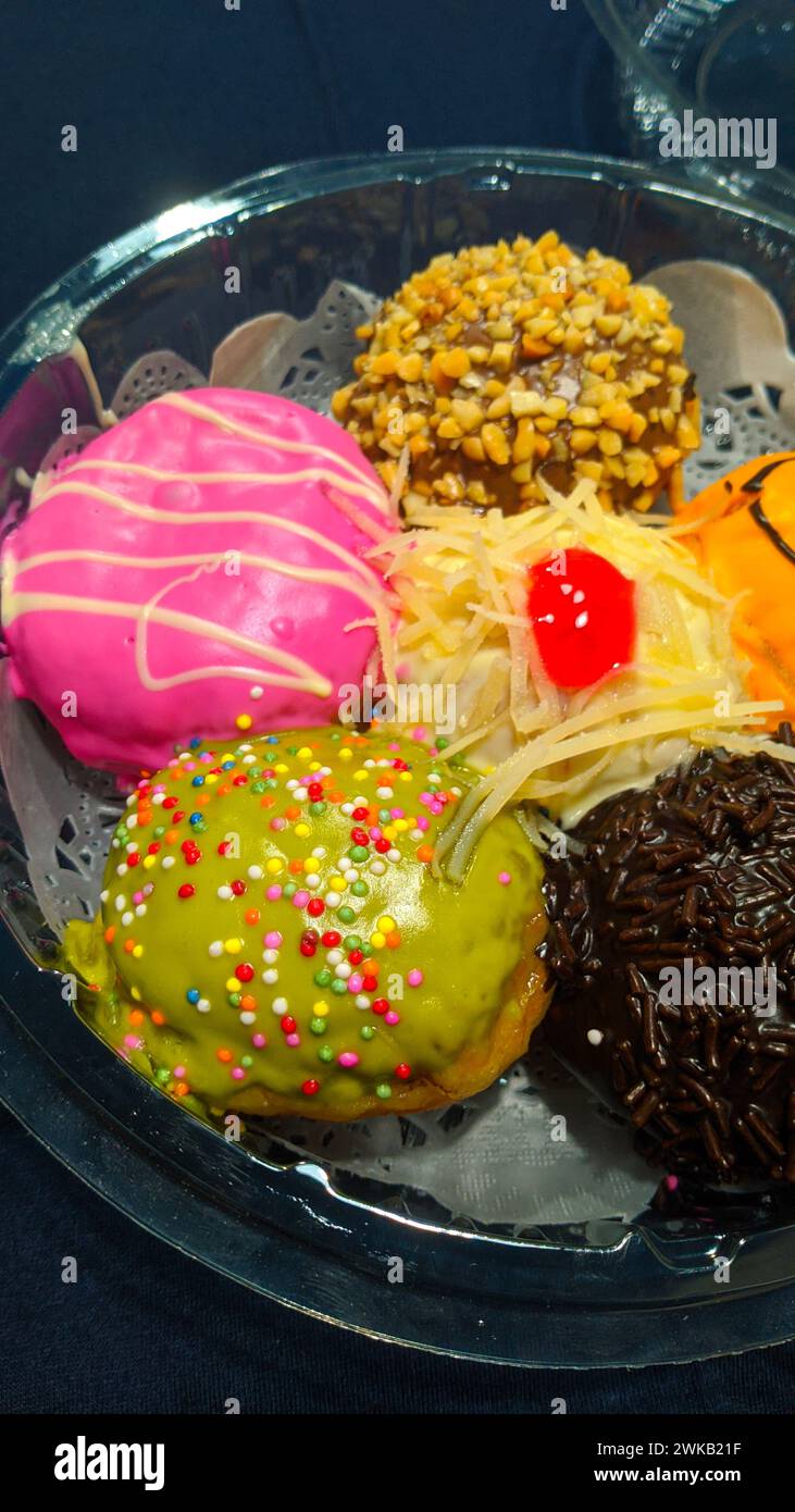 Close up of donuts with various color variants and toppings Stock Photo ...