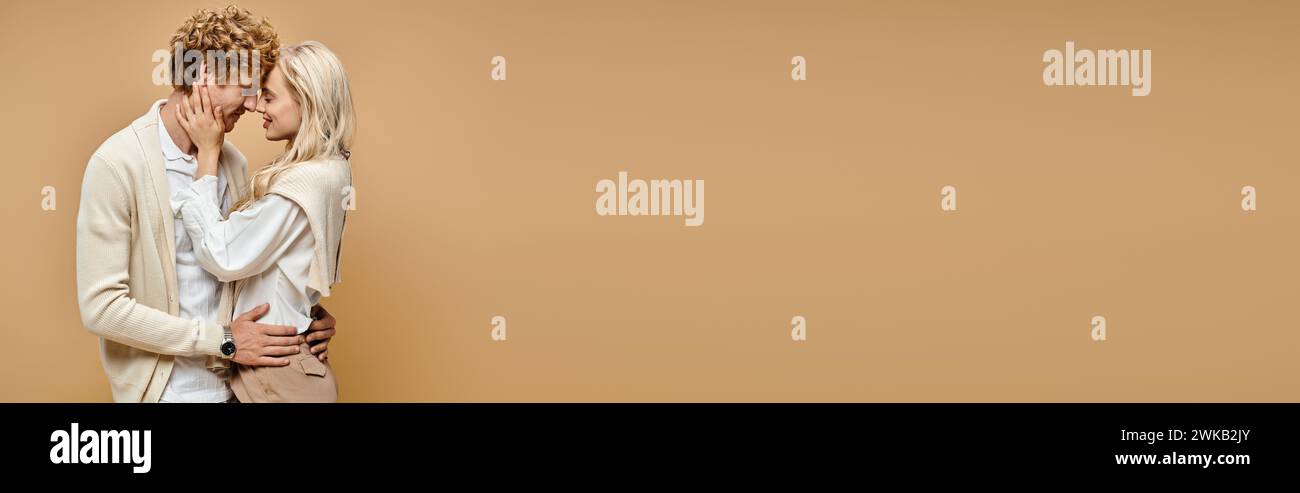 side view of young stylish couple hugging face to face with closed eyes ...