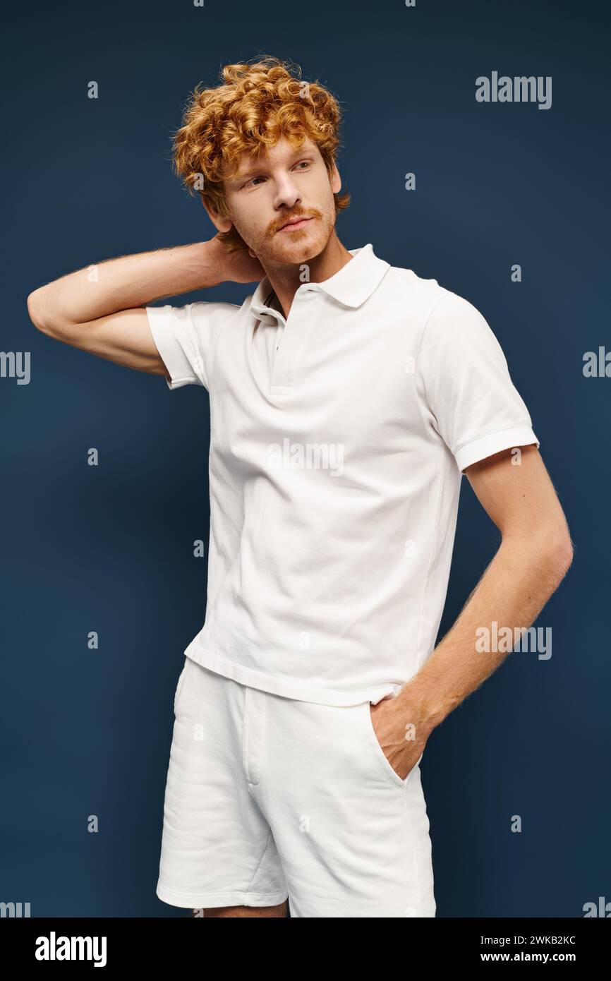 wealthy redhead man in white attire with hand in pocket looking away on ...