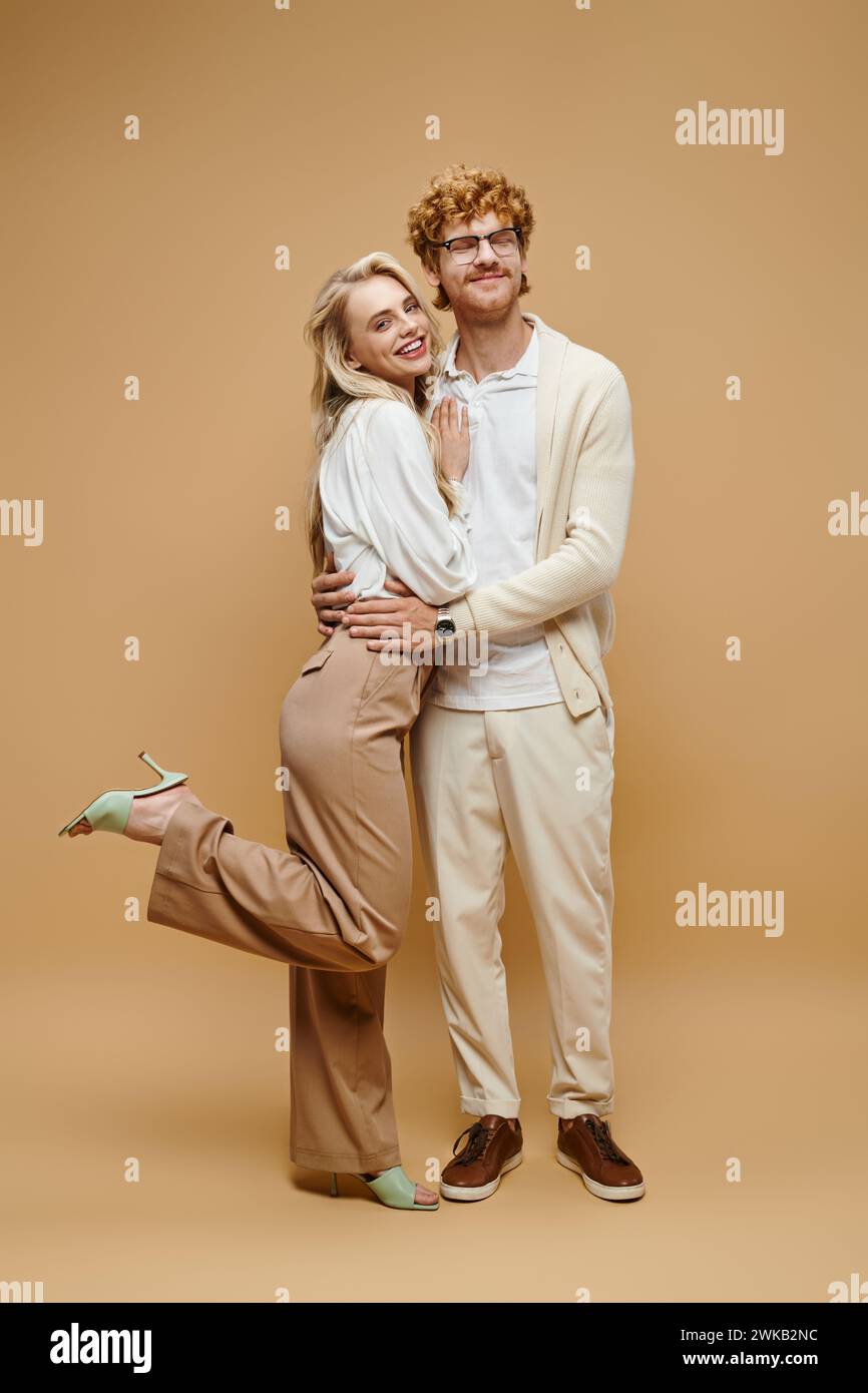 full length of carefree young models in light-colored clothes embracing ...