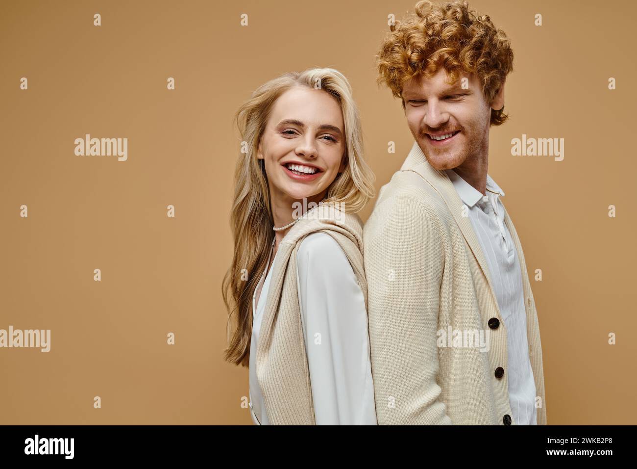 joyous young models in light-colored vintage attire standing back to ...