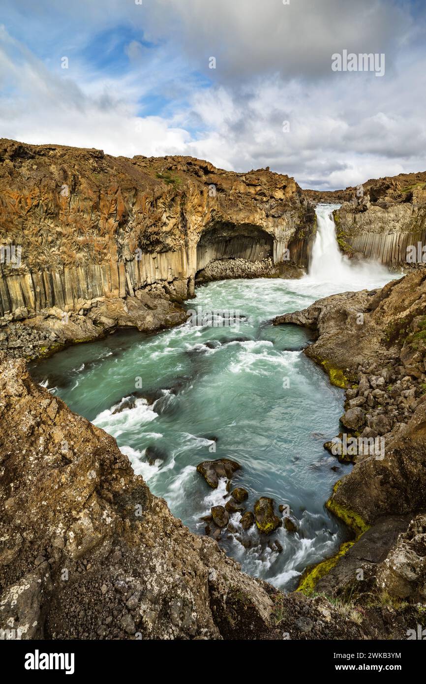 View from a vantage point of a waterfall cascading down a rock face ...