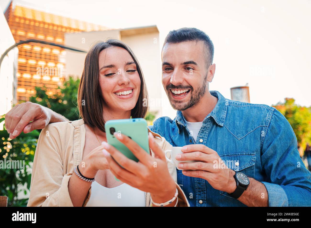 Real caucasian couple using a cellphone device to search on internet ...