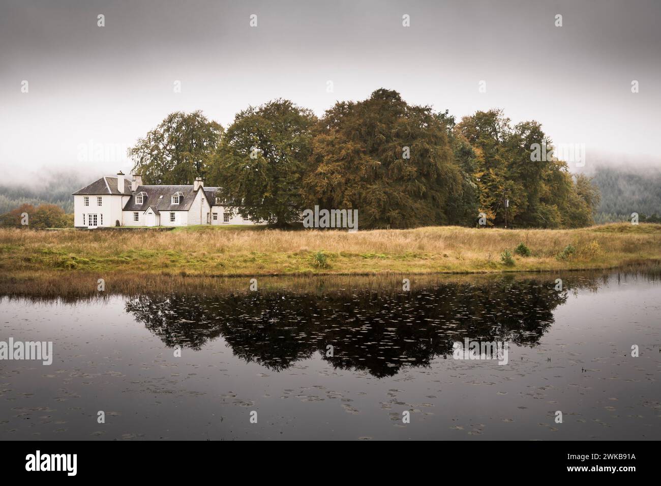 Large white house in Scotland. Remote country house beside lake in ...