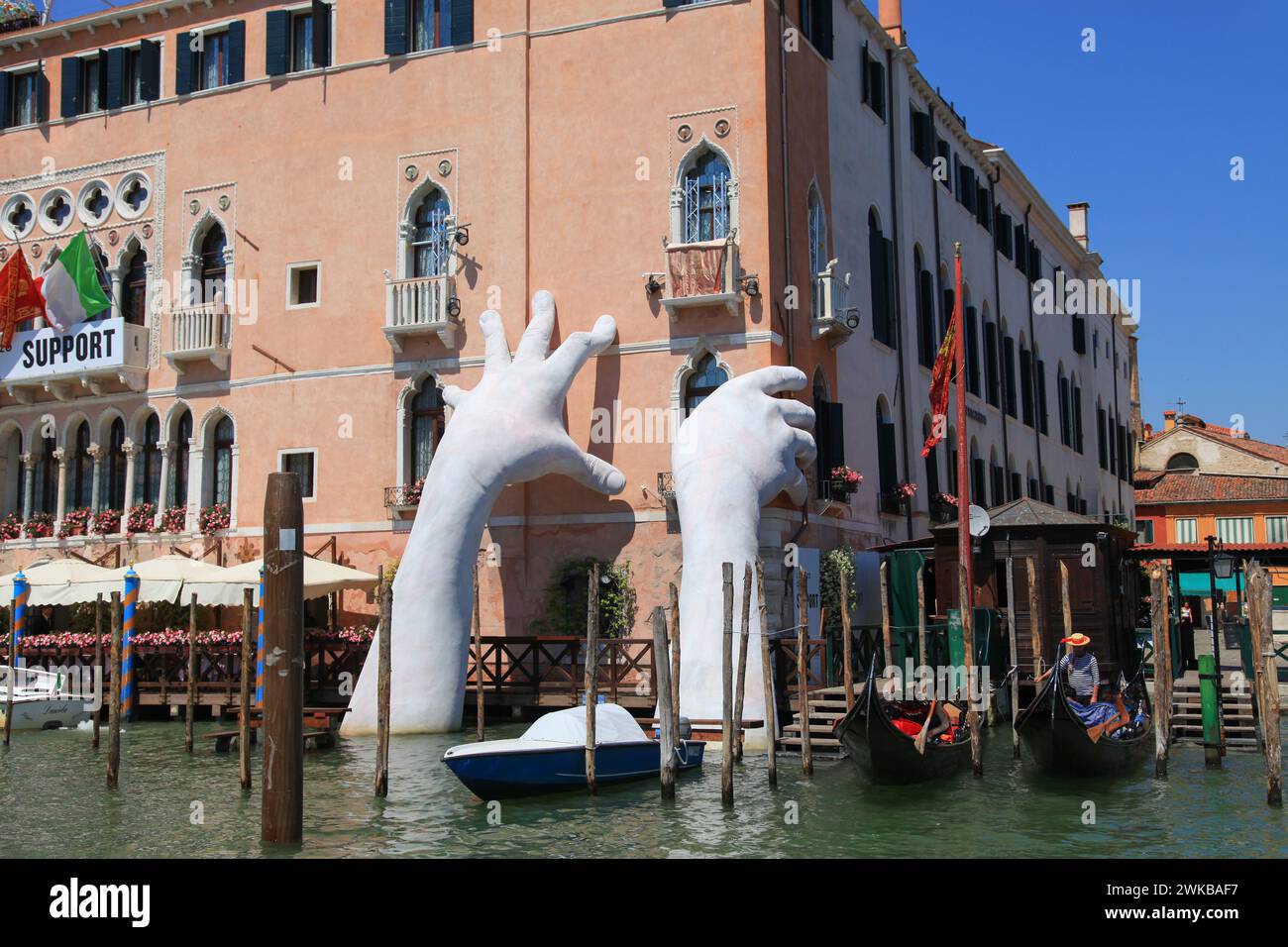 Sculpture of giant white hands in the Grand Canal in Venice, Italy ...