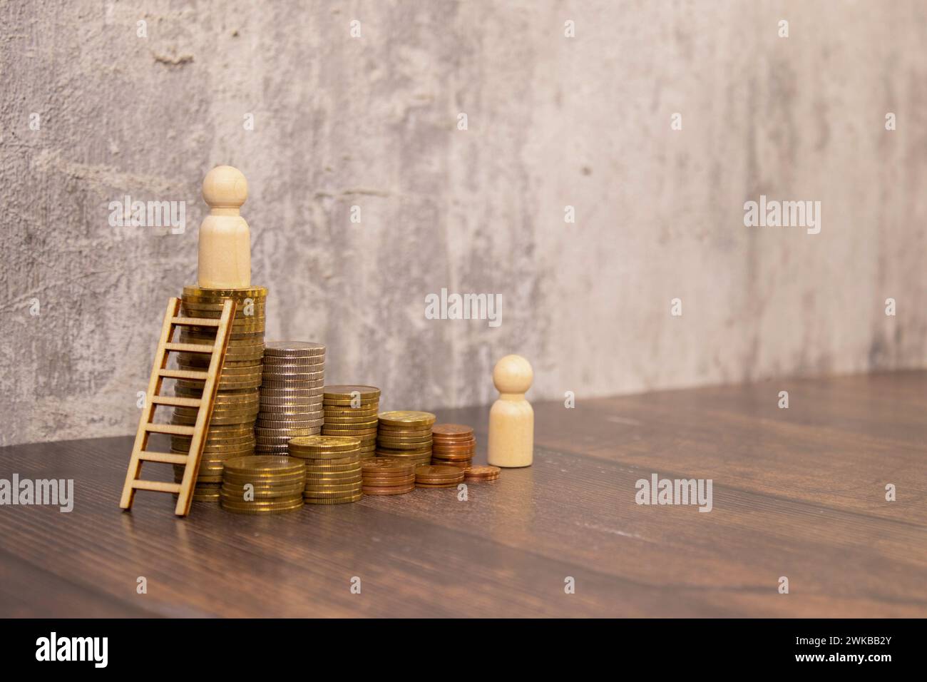 Side view of businessman with a suitcase climbing giant coin stacks ...