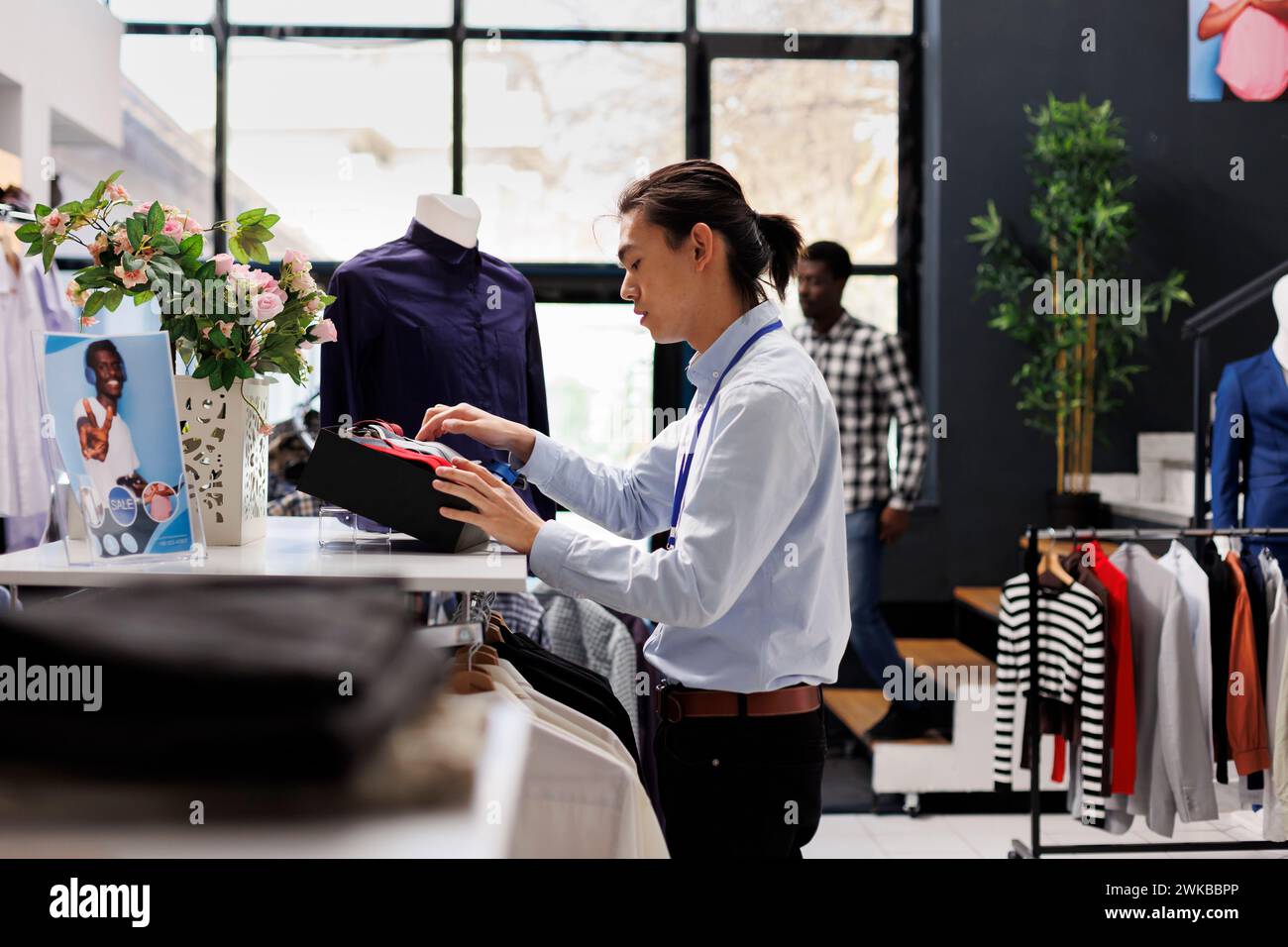 Asian manager arranging elegant tie and clothes, preparing clothing ...