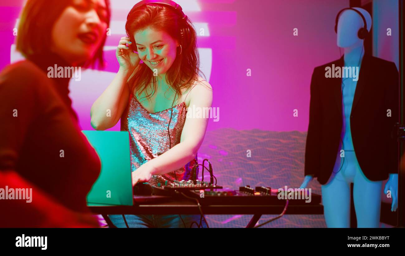 Smiling girl mixing music at DJ station, creating cheerful atmosphere ...