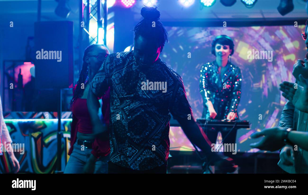 Group of friends dancing in the club, enjoying live DJ performance on ...