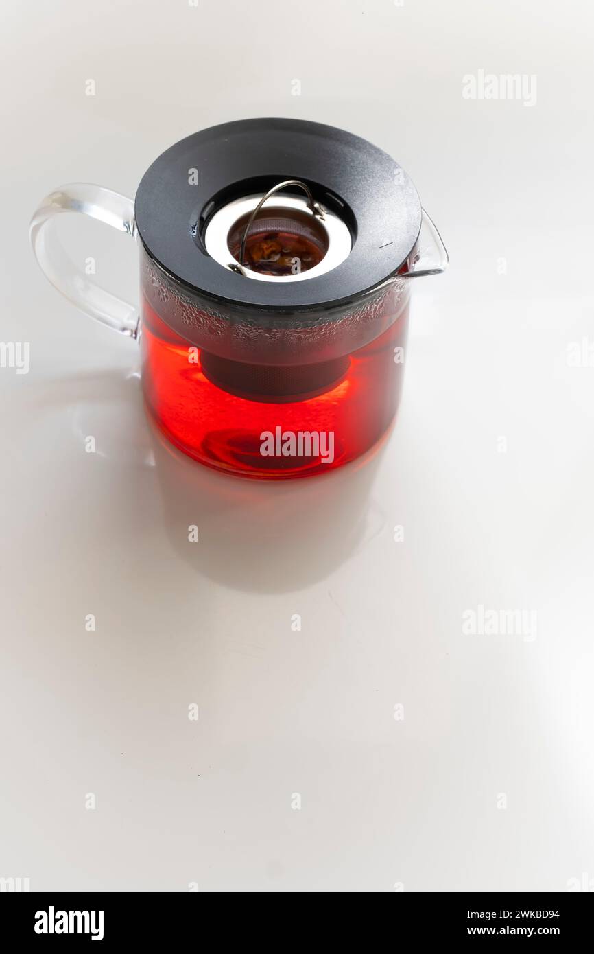 a glass teapot with a fruit infusion, infuser pitcher with a strawberry ...