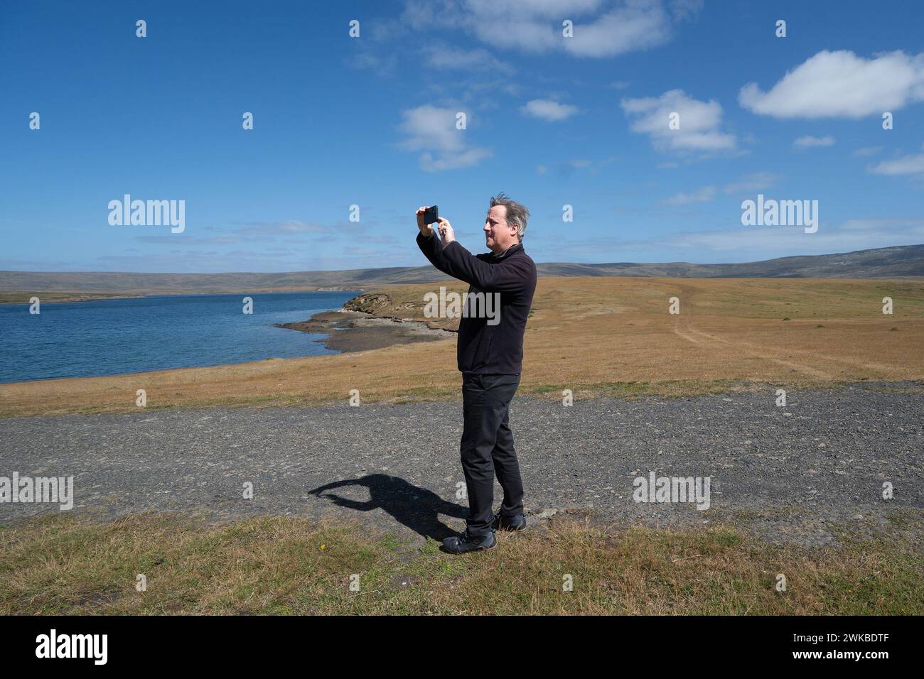 Foreign Secretary Lord David Cameron takes a photograph of San Carlos ...
