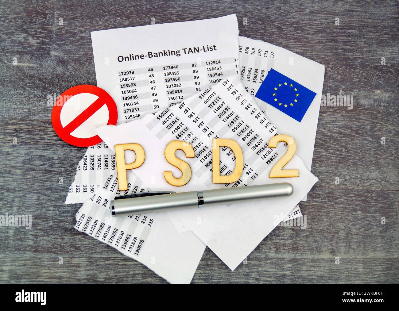 lettering 'PSD2', fountain pen, European flag and prohibition sign with ...