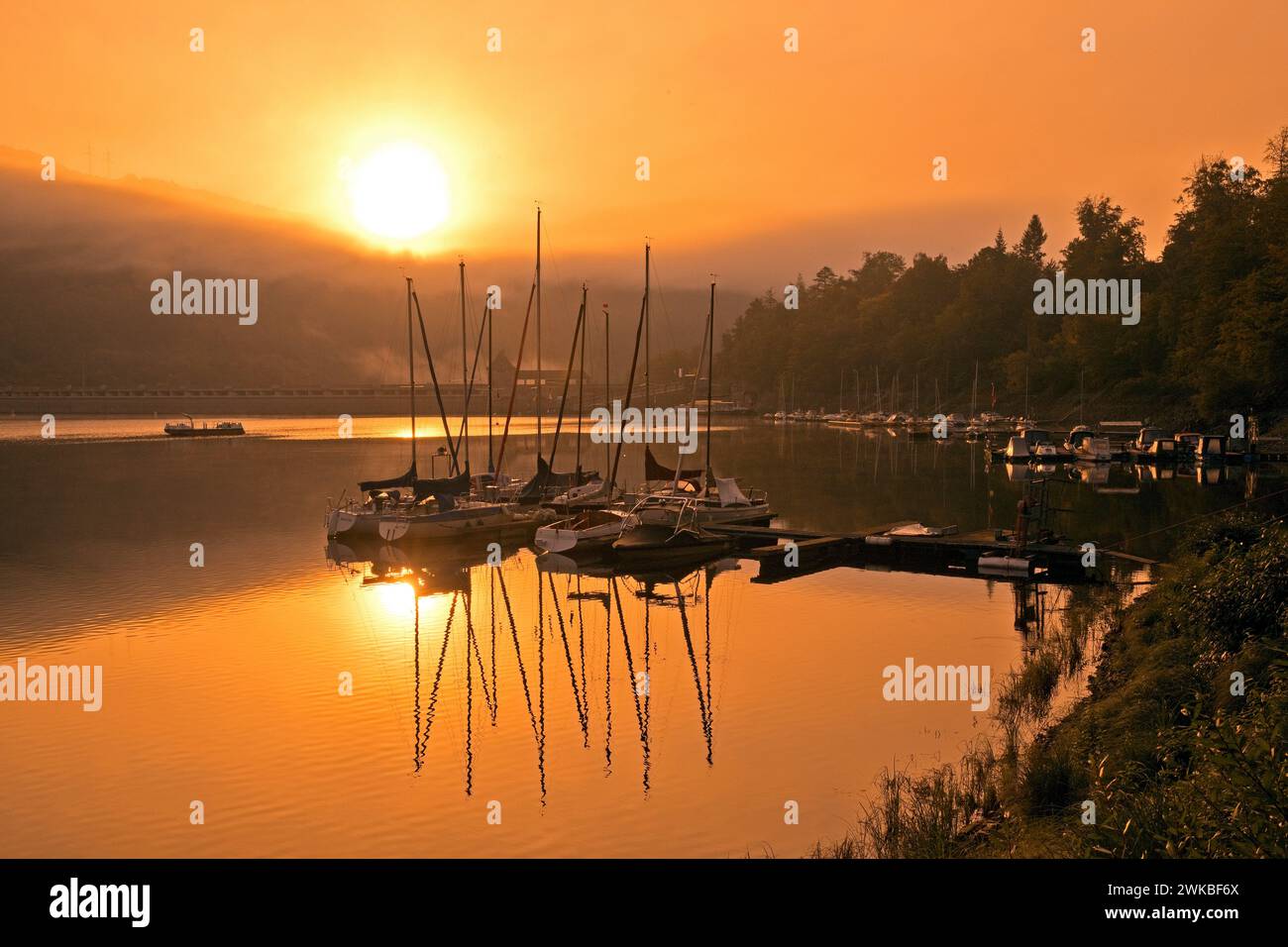 Eder dam with dam wall and pleasure boats on the Edersee in the early ...