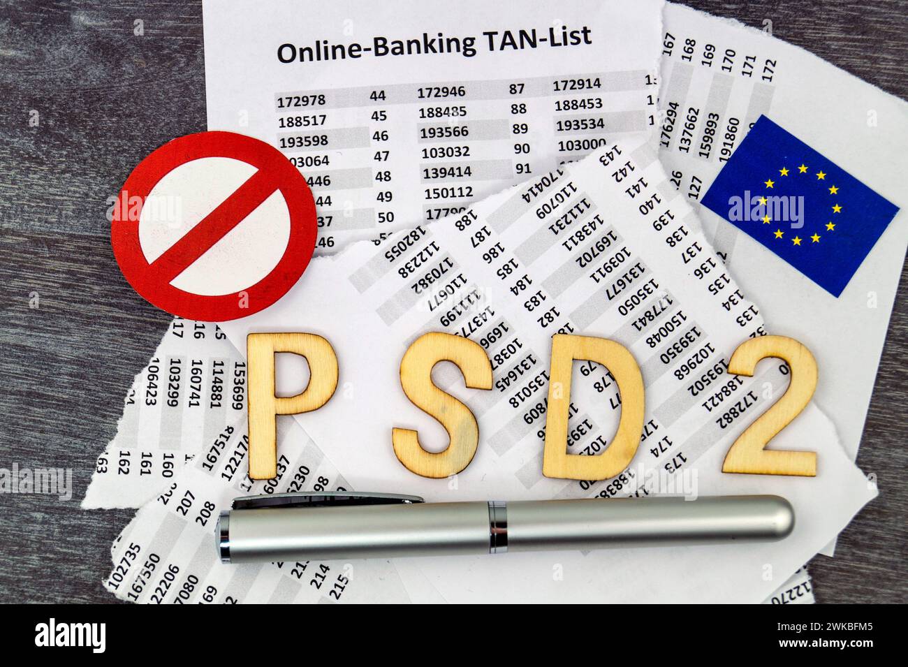 lettering 'PSD2', fountain pen, European flag and prohibition sign with ...