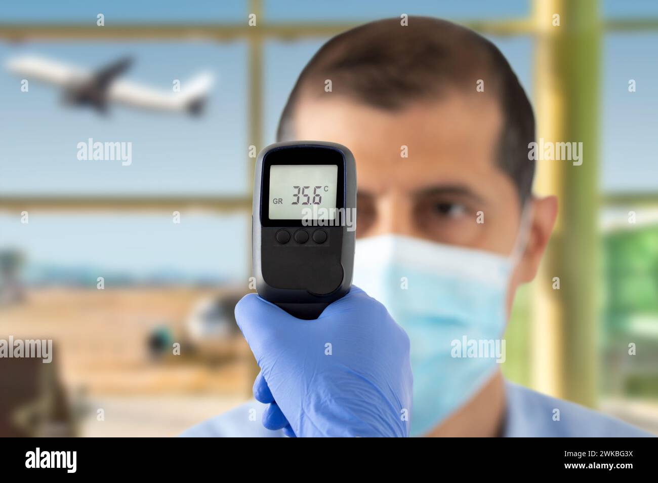 Airport worker measuring passenger hi-res stock photography and images ...