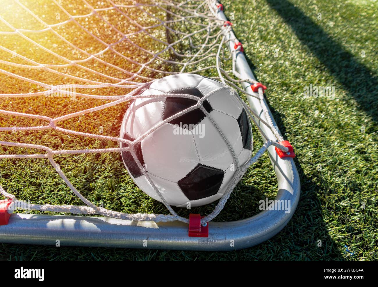 Close up of goal with a soccer ball in net with lens flare Stock Photo ...