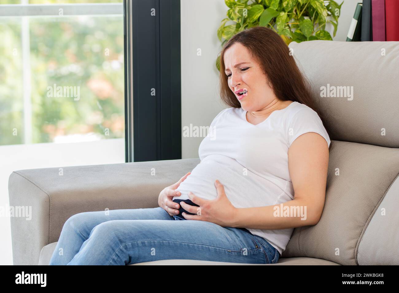 Sick woman with stomach pain due to diarrhea Stock Photo - Alamy