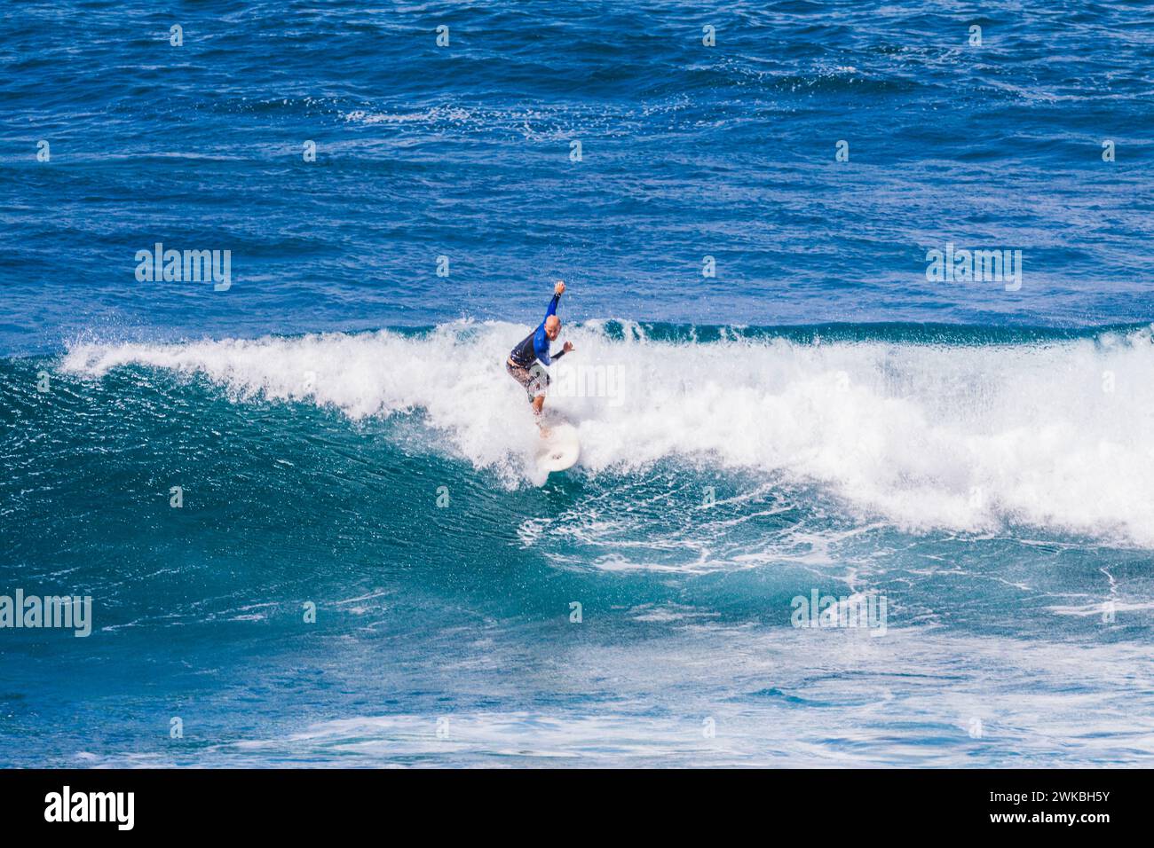 Surfer enjoying waves on west coast of the island of Maui in Hawaii ...