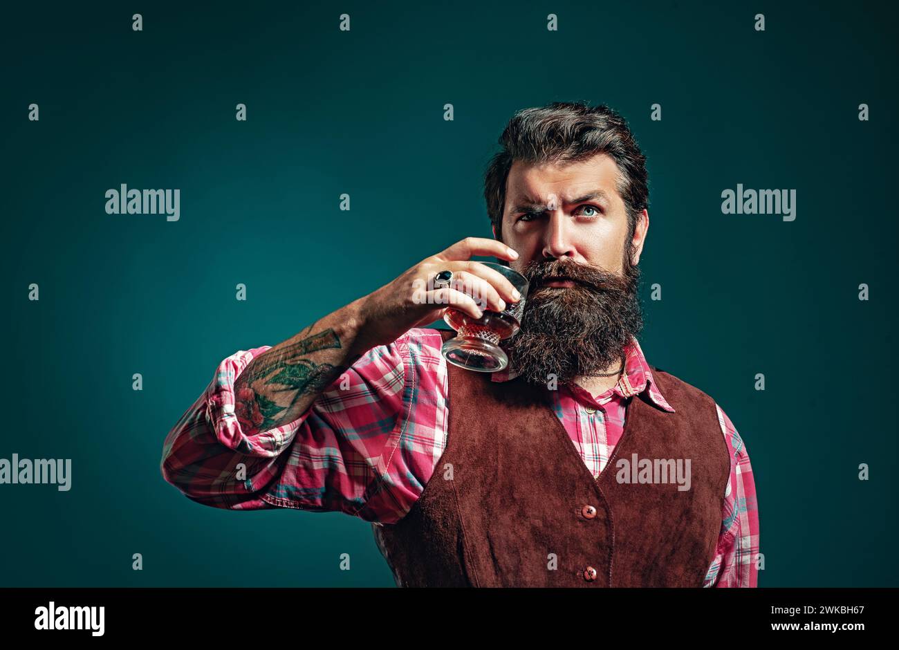 Whiskey. Fashionable man in white shirt and suspenders. Luxury beverage ...
