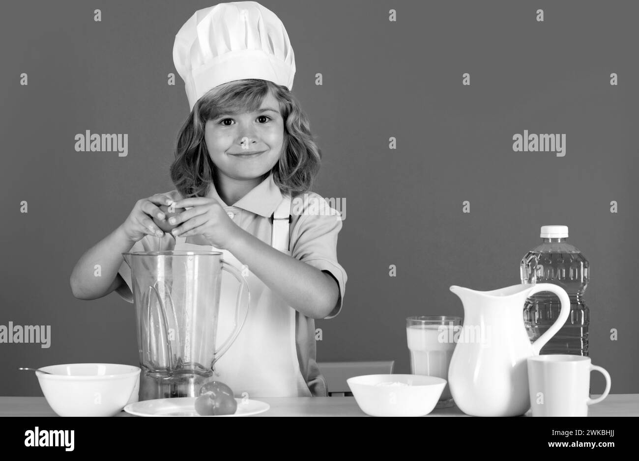 Cooking children. Chef kid boy making fresh vegetables for healthy eat ...