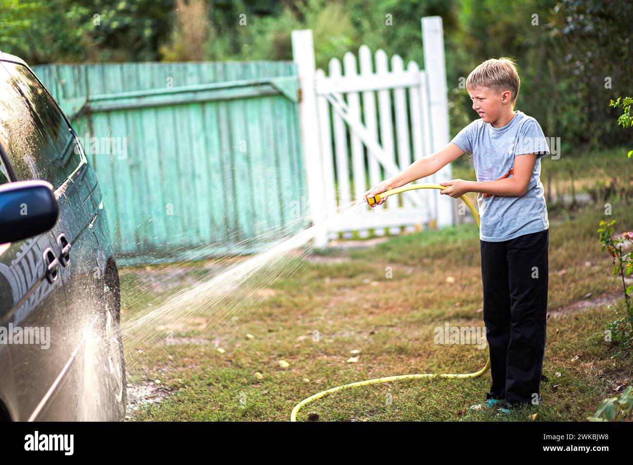 Teenage boy washing car hi-res stock photography and images - Alamy