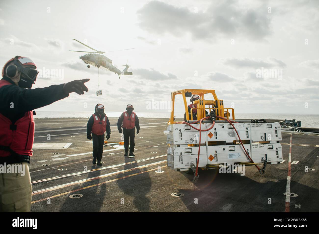 Sailors assigned to weapons department transport ammo on the flight ...