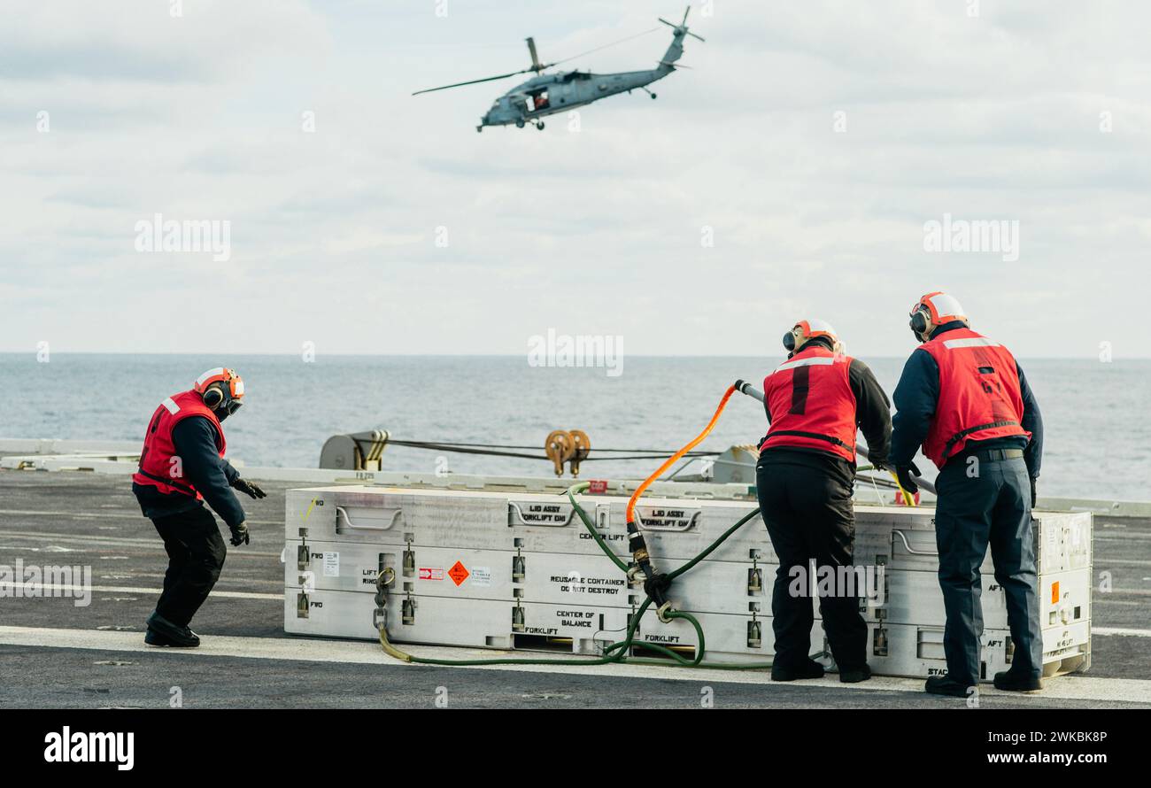 Sailors assigned to weapons department transport ammo on the flight ...