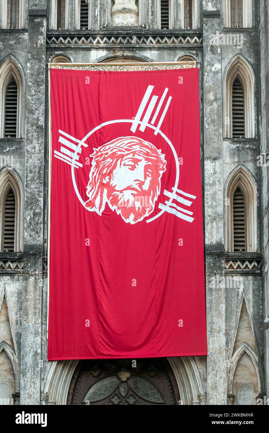 A large flag with a portrait of Jesus Christ hanging on a church facade ...