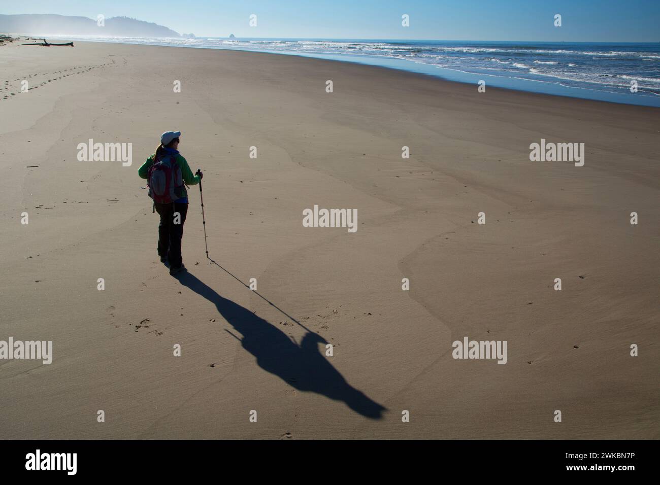 Beach hiker silhouette to Cape Meares, Bayocean Peninsula, Oregon Stock ...
