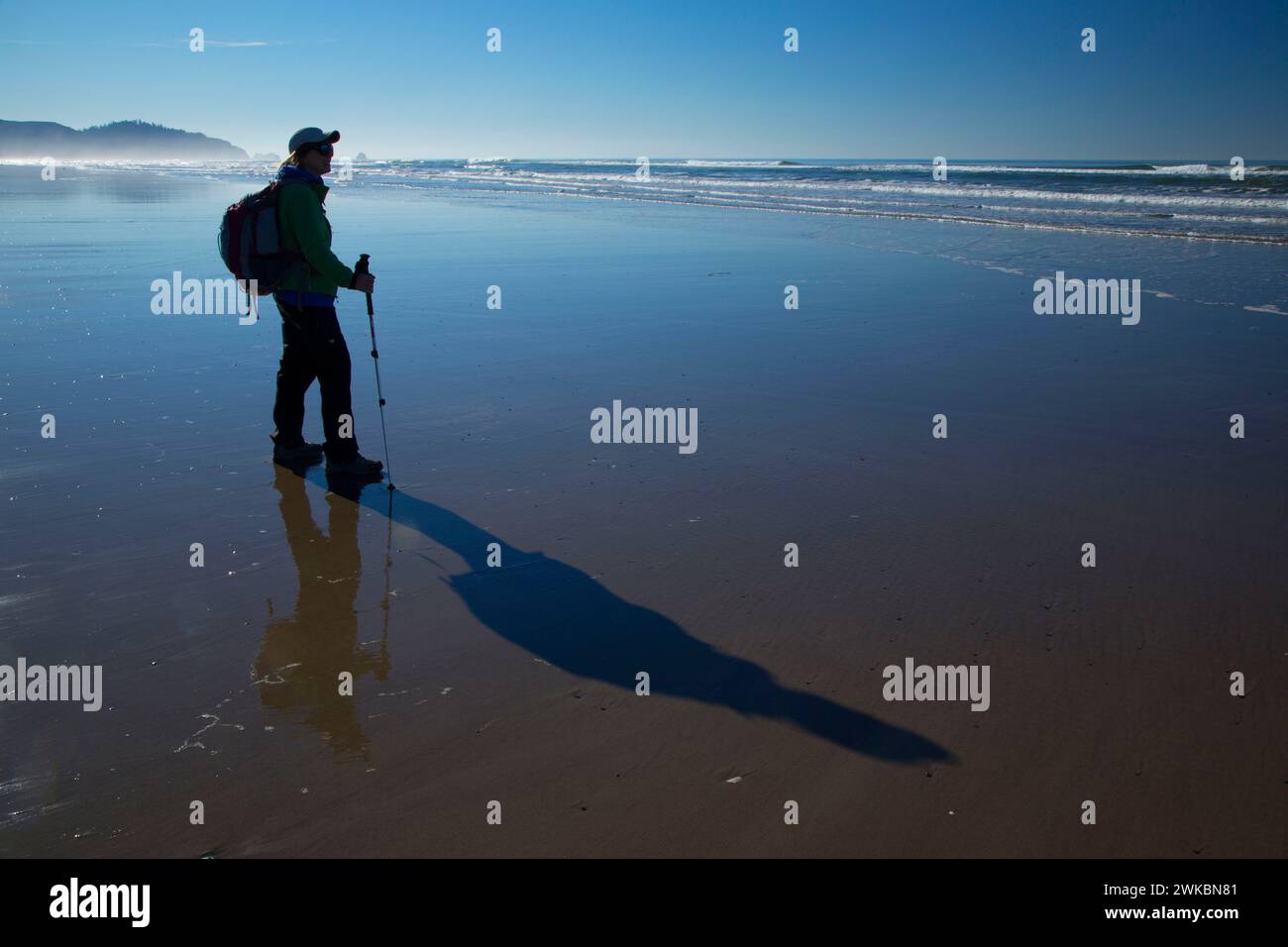 Beach hiker silhouette to Cape Meares, Bayocean Peninsula, Oregon Stock ...