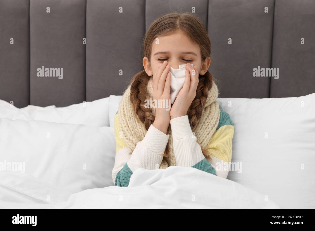 Sick girl with tissue coughing on bed at home Stock Photo - Alamy