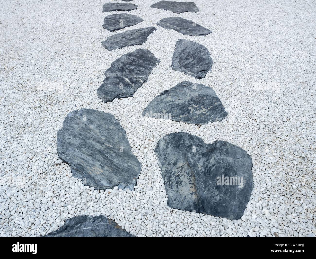 Dark blue granite slabs cut into free-form shapes were laid out to ...