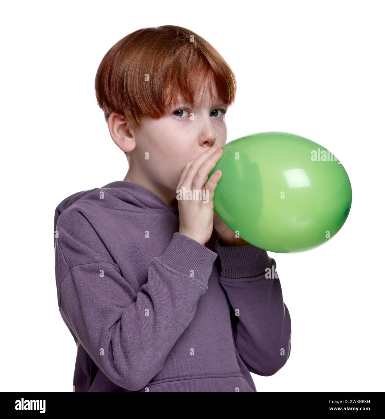 Boy inflating green balloon on white background Stock Photo - Alamy