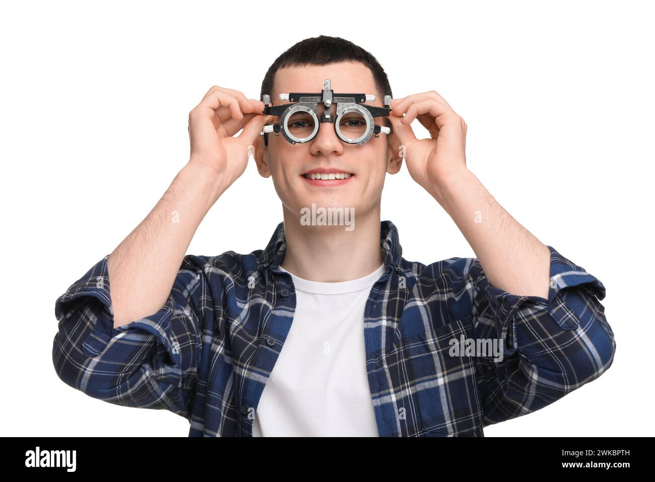 Vision testing. Young man with trial frame on white background Stock ...