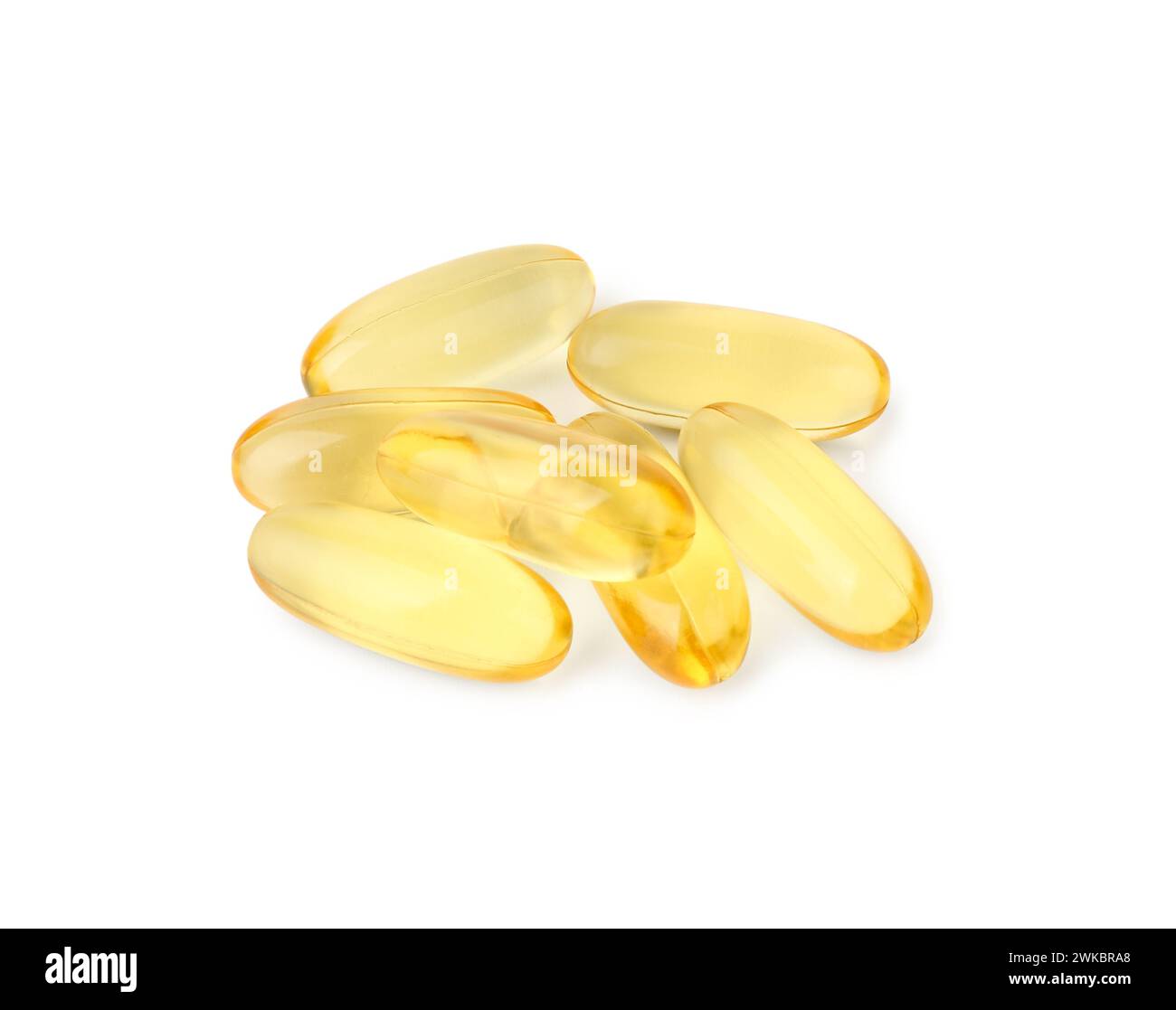 Many yellow vitamin capsules isolated on white Stock Photo - Alamy