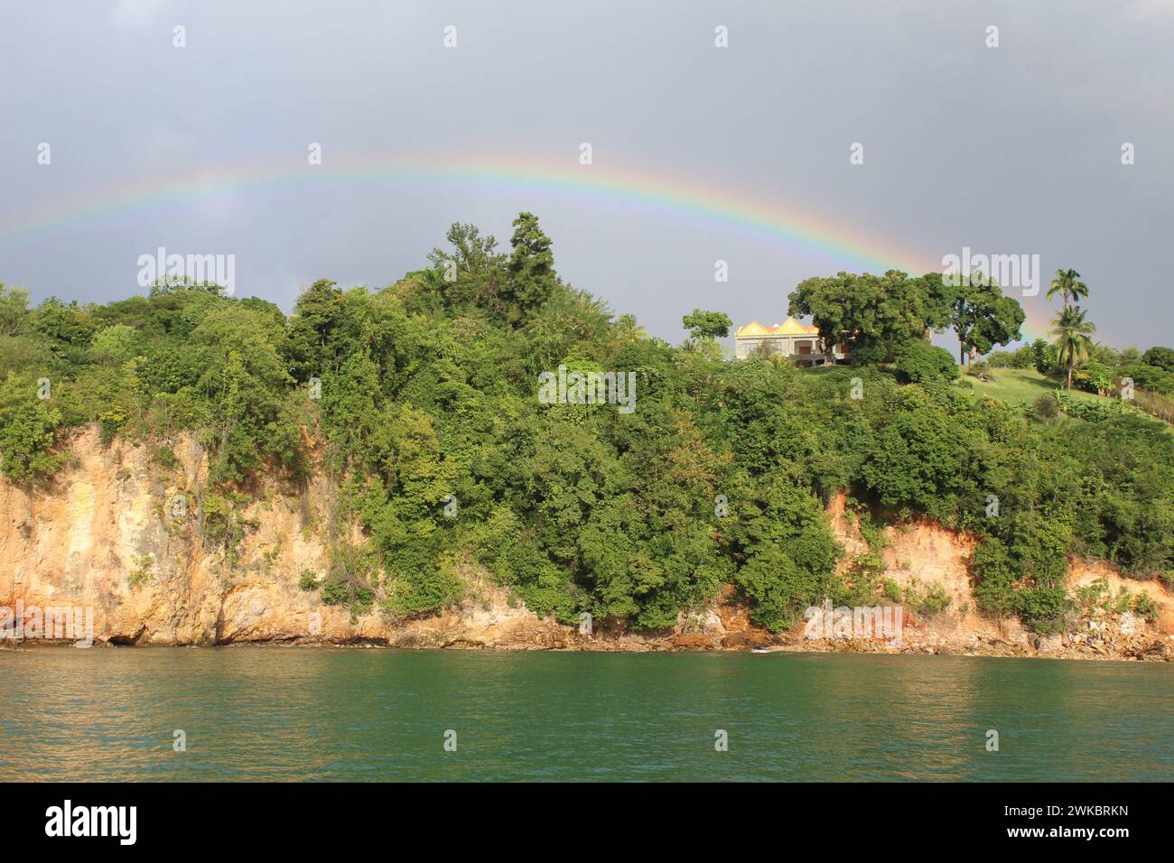 Rainbow over a house on a tall cliff in St. Lucia Stock Photo - Alamy