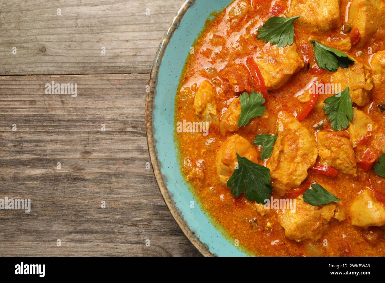 Delicious chicken curry on wooden table, top view. Space for text Stock ...